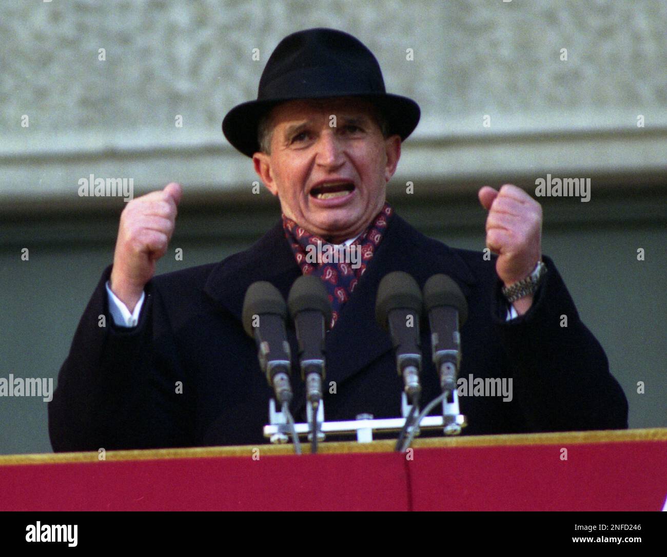Romanian leader Nicolae Ceausescu addresses the public from the balcony ...