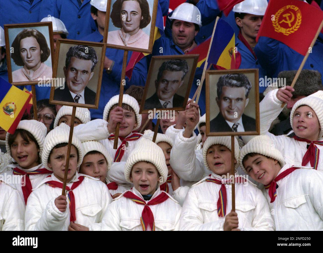 A group of children dressed in white with red scarfs are pictured ...