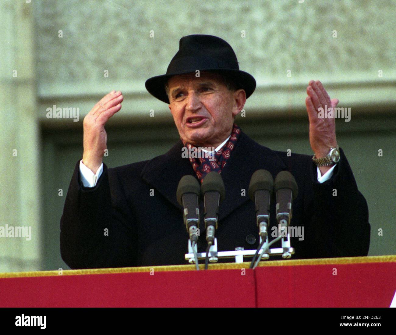Romanian leader Nicolae Ceausescu addresses the public from the balcony ...
