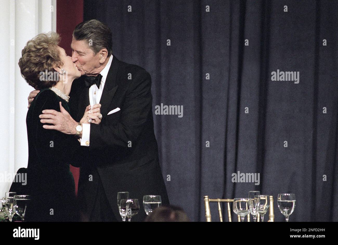 Former President Ronald Reagan kisses his wife Nancy during a birthday ...