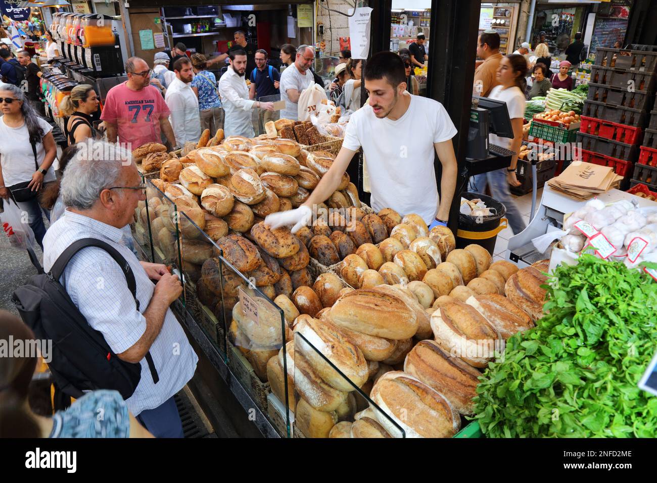 JERUSALEM, ISRAEL - OCTOBER 28, 2022: People visit bakery at Mahane ...