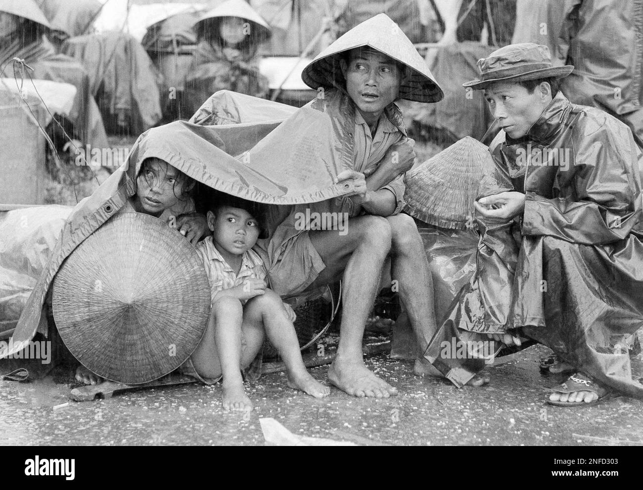 A South Vietnamese’s refugee family huddles under Poncho at My Chanh ...