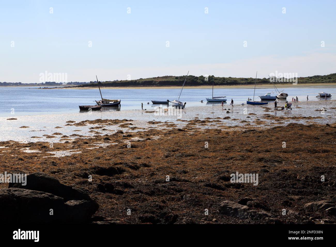 Beach at low tide with moored boats at Plage de Mousterian, Mousterian ...