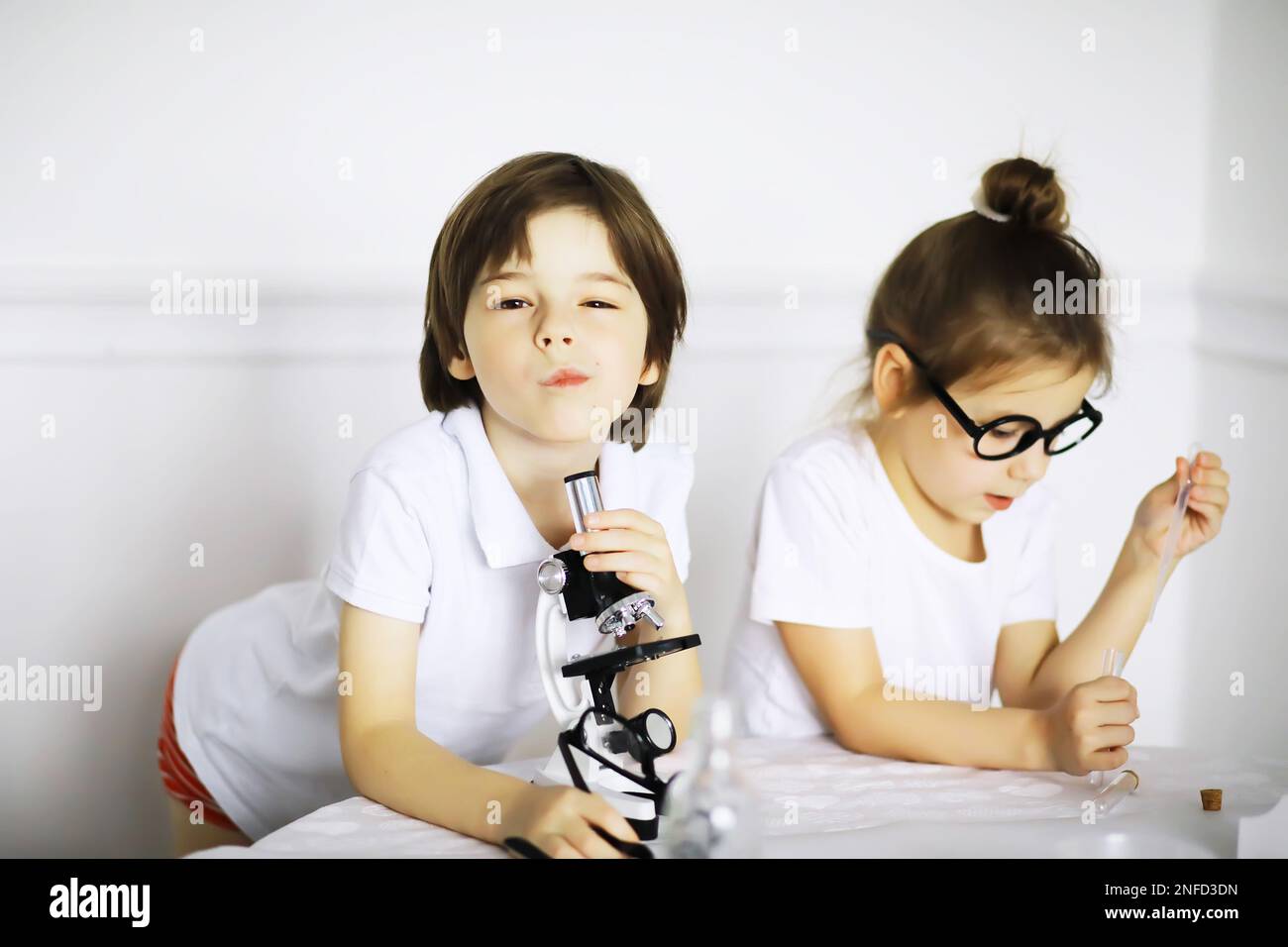 Two cute children at chemistry lesson making experiments isolated on ...