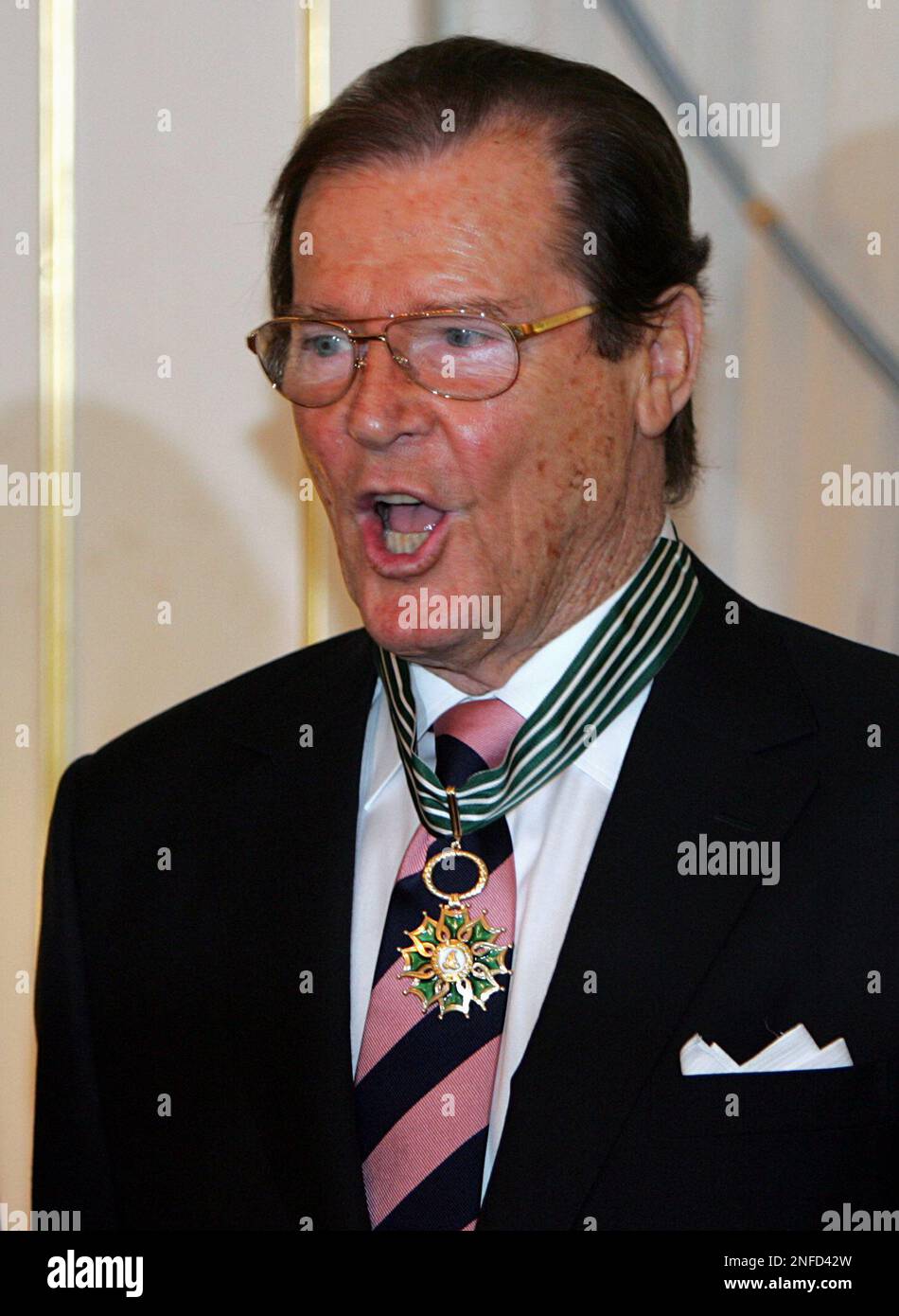 British movie star Roger Moore reacts after he was made Commander of ...