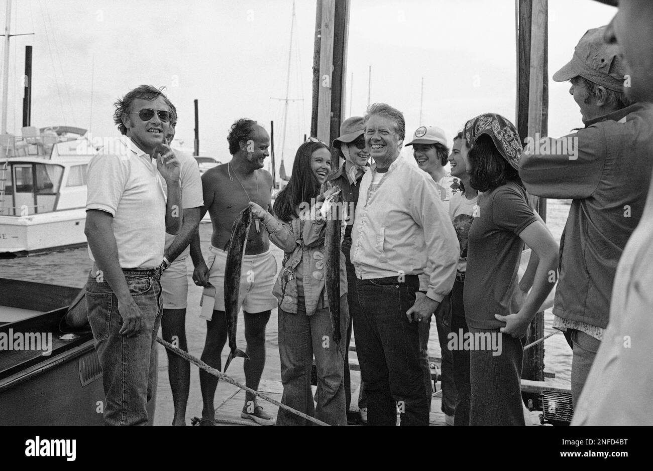 Annette Carter, wife of the youngest Carter son, Jeff, holds up two ...