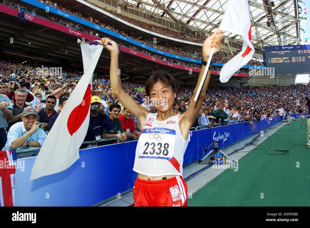 Naoko Takahashi of Japan waves Japanese flags after winning the women's ...