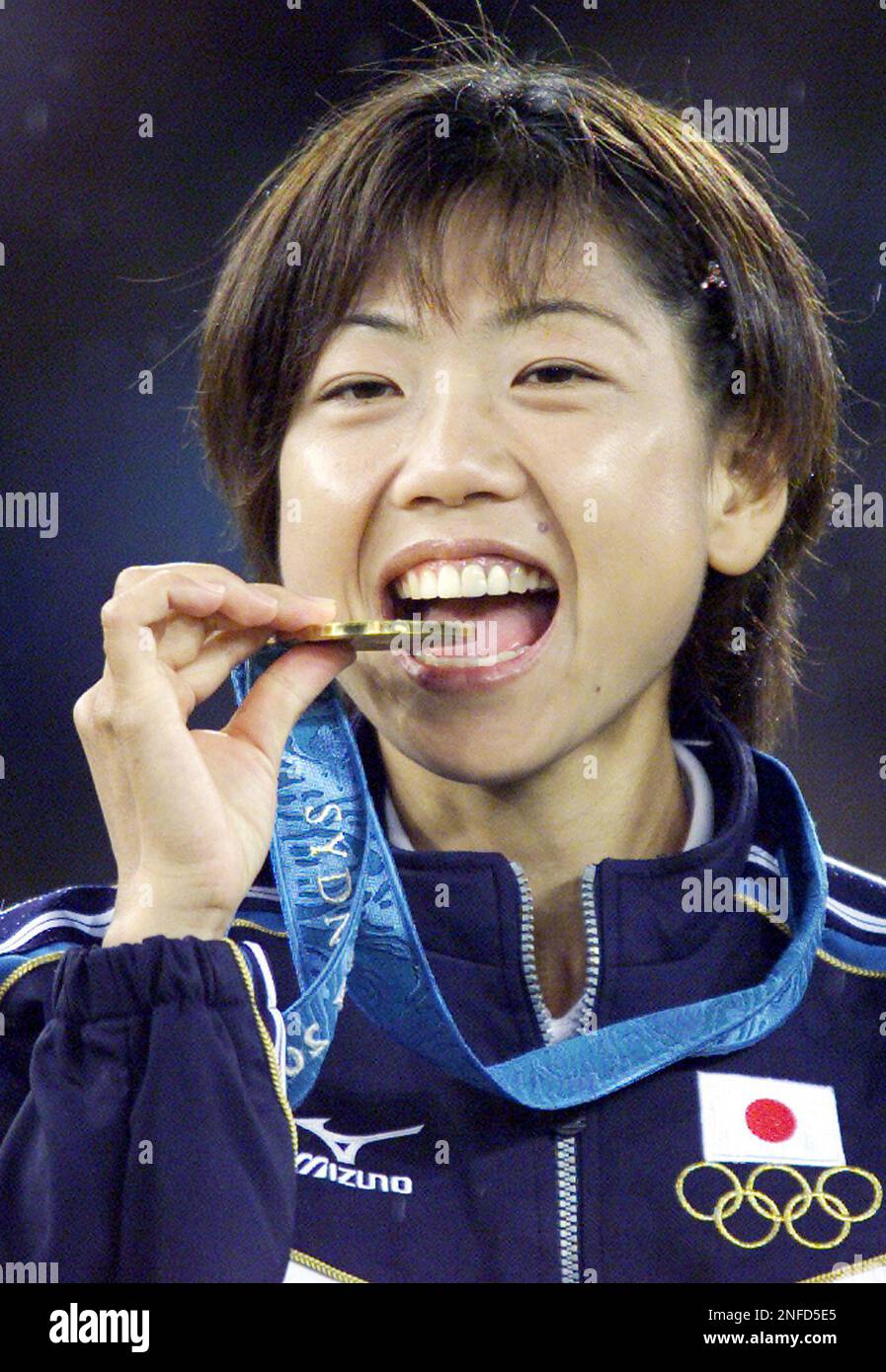 Japan's Naoko Takahashi goes to bite the gold medal she won in the ...