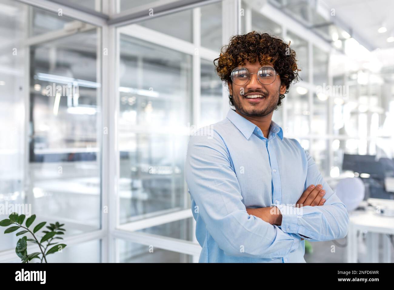 Portrait of young successful businessman inside modern office, hispanic ...