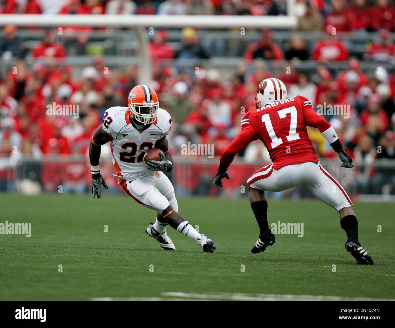 Illinois' Daniel Dufrene (22) runs against Wisconsin's Allen Langford ...
