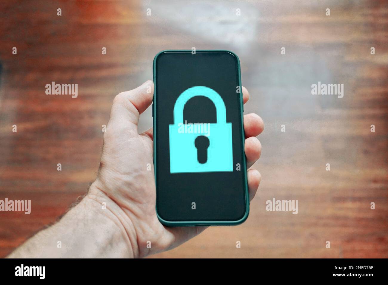hand holding a phone with a padlock security symbol Stock Photo - Alamy
