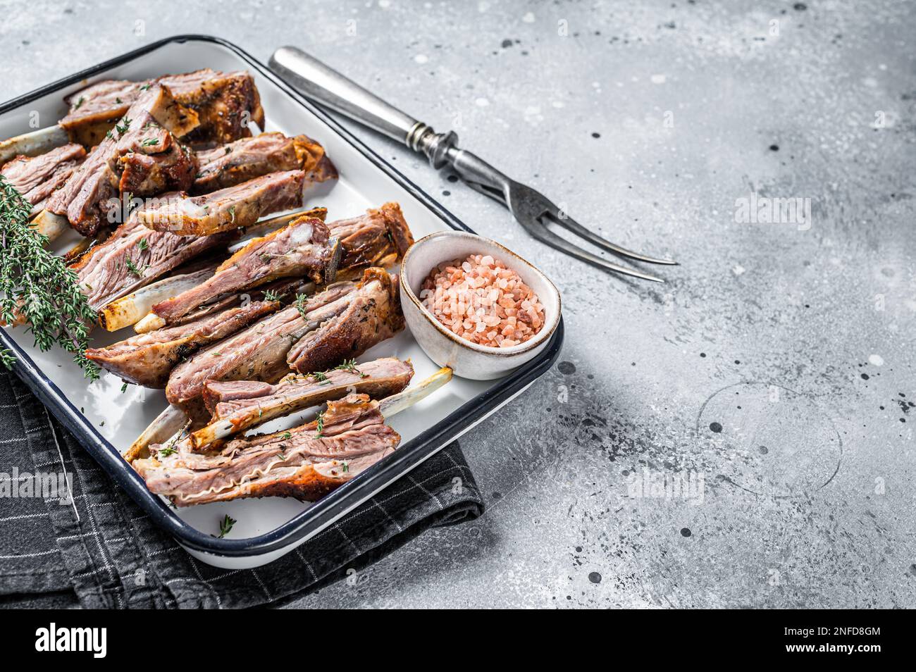BBQ smoked lamb ribs, mutton spareribs, sliced meat in steel tray with ...