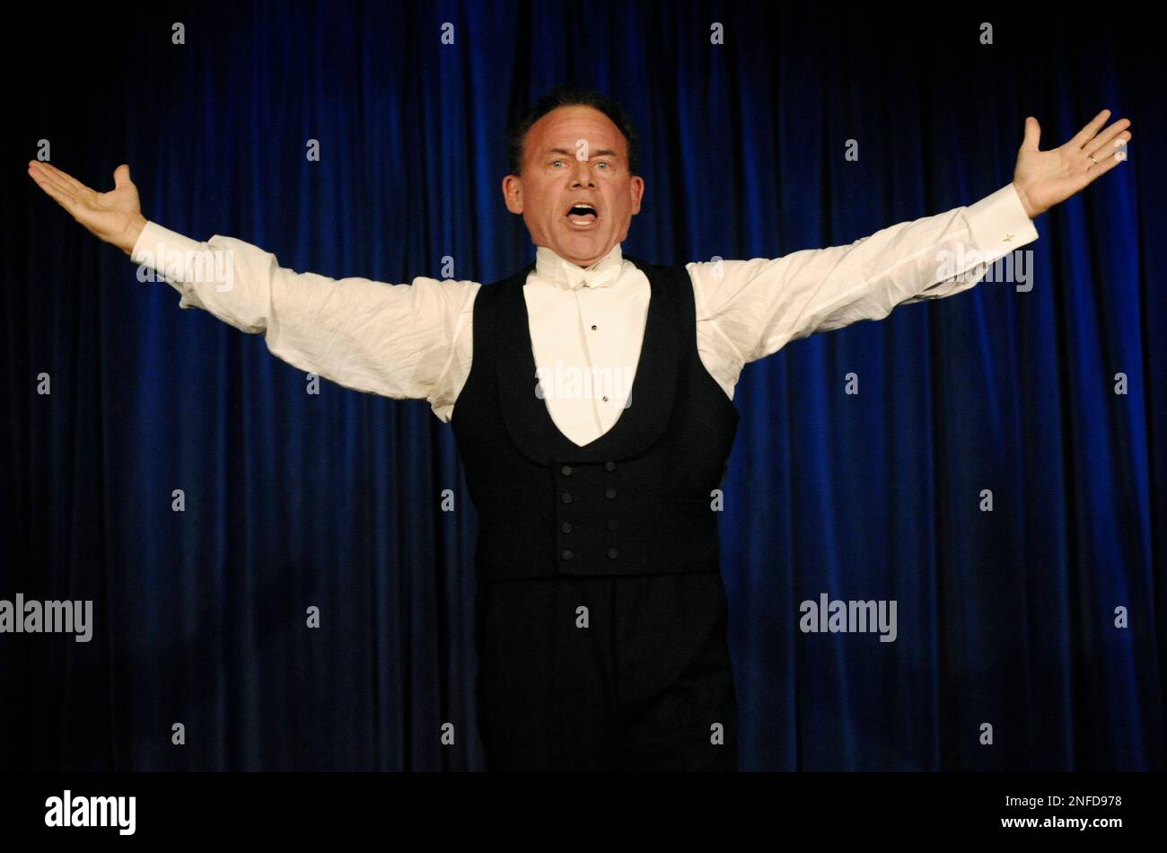 Jim Bentley performs as Harry Houdini during a reception to celebrate ...
