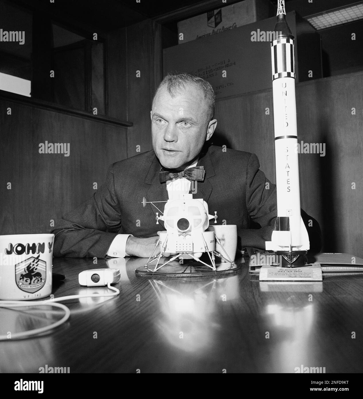 Astronaut John Glenn poses with a model of the Mercury Space Ship atop ...
