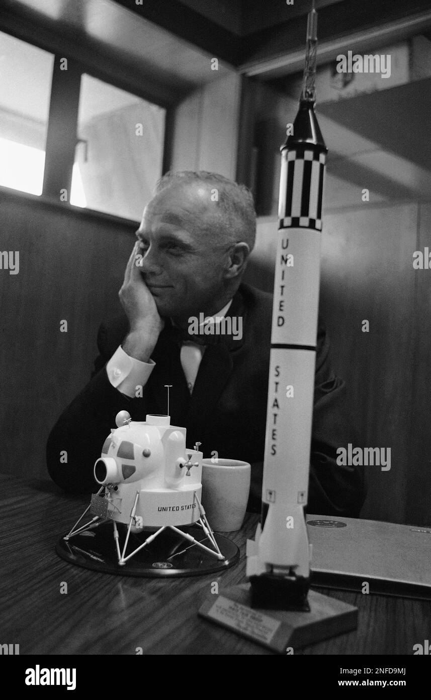 Astronaut John Glenn poses with a model of the Mercury Space Ship atop ...