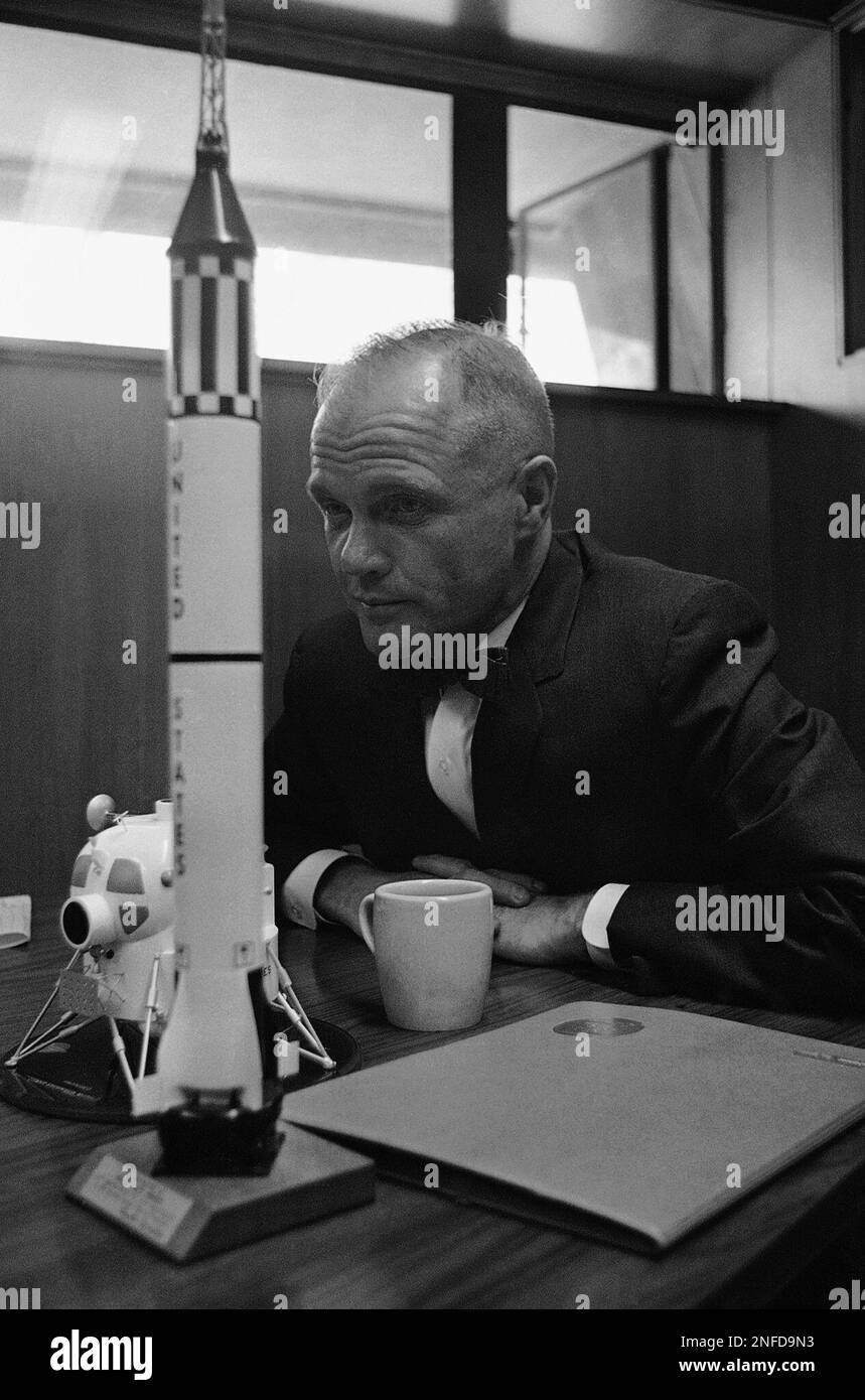Astronaut John Glenn poses with a model of the Mercury Space Ship atop ...