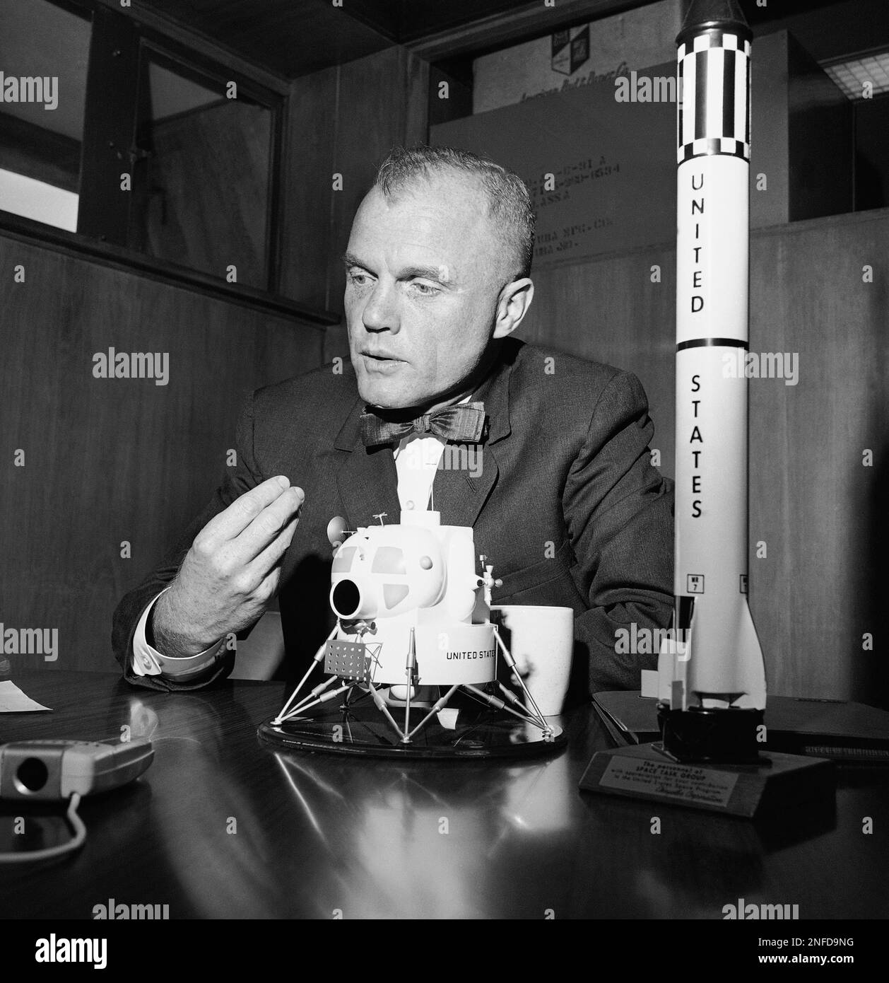 Astronaut John Glenn poses with a model of the Mercury Space Ship atop ...
