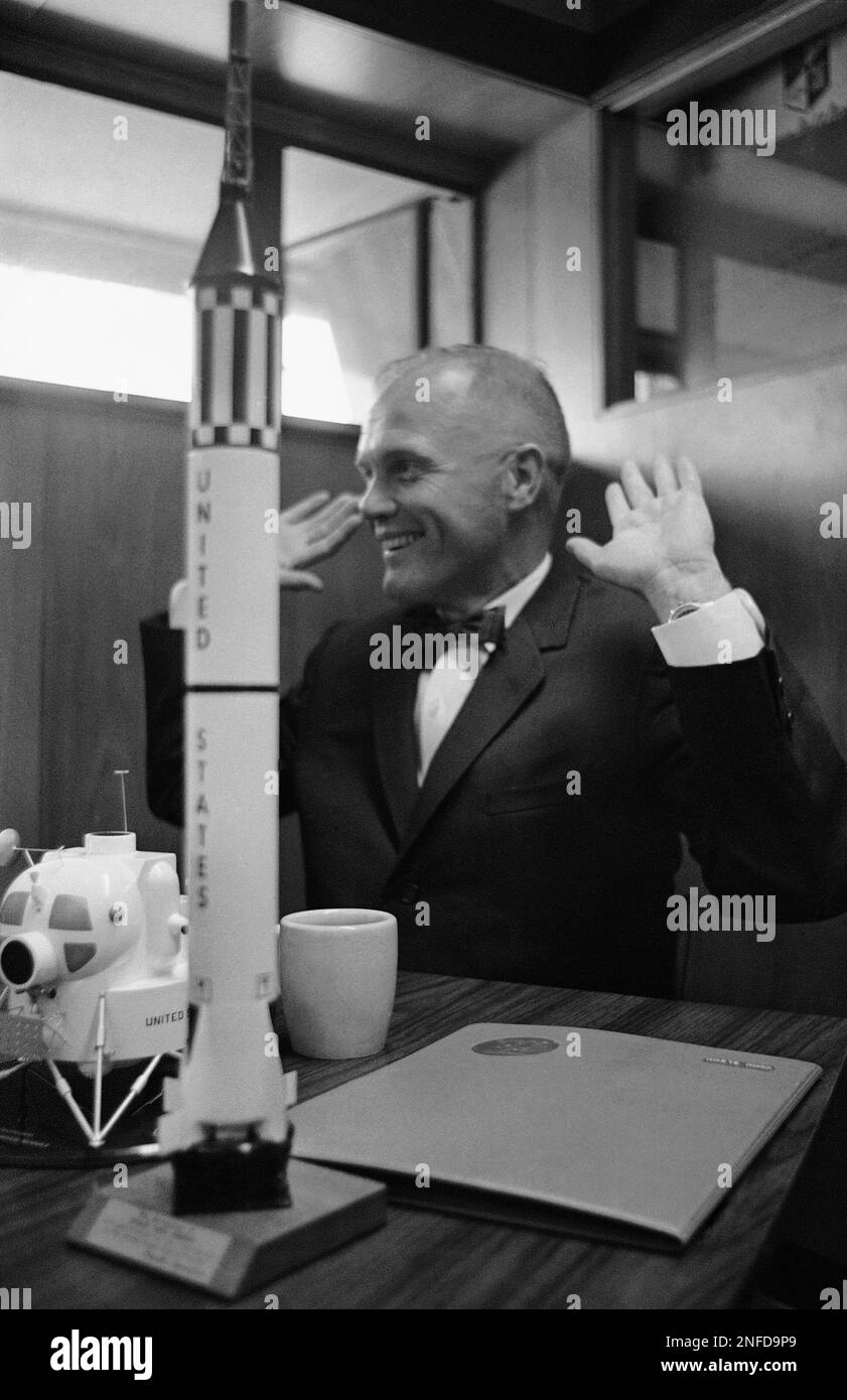 Astronaut John Glenn poses with a model of the Mercury Space Ship atop ...