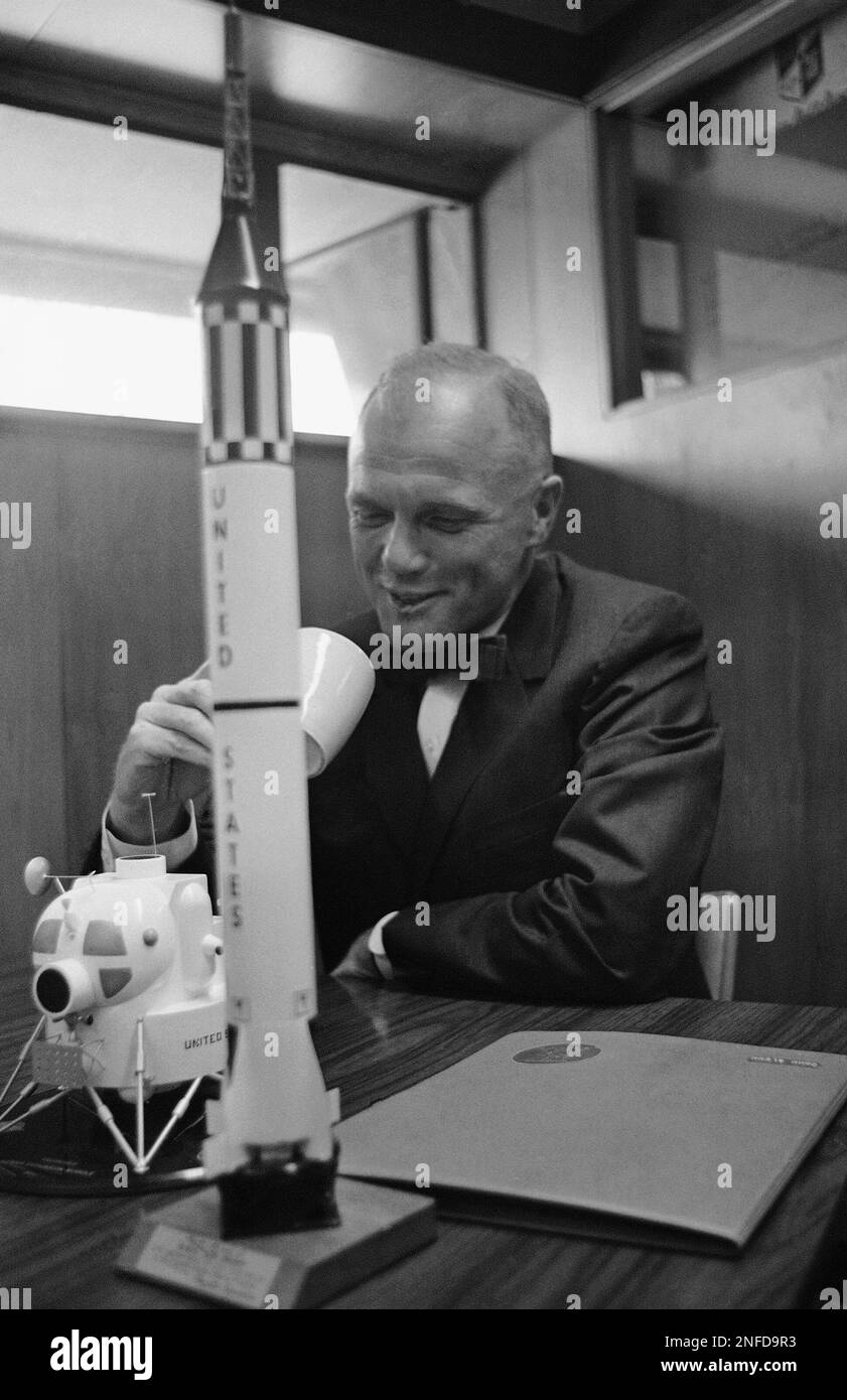 Astronaut John Glenn poses with a model of the Mercury Space Ship atop ...