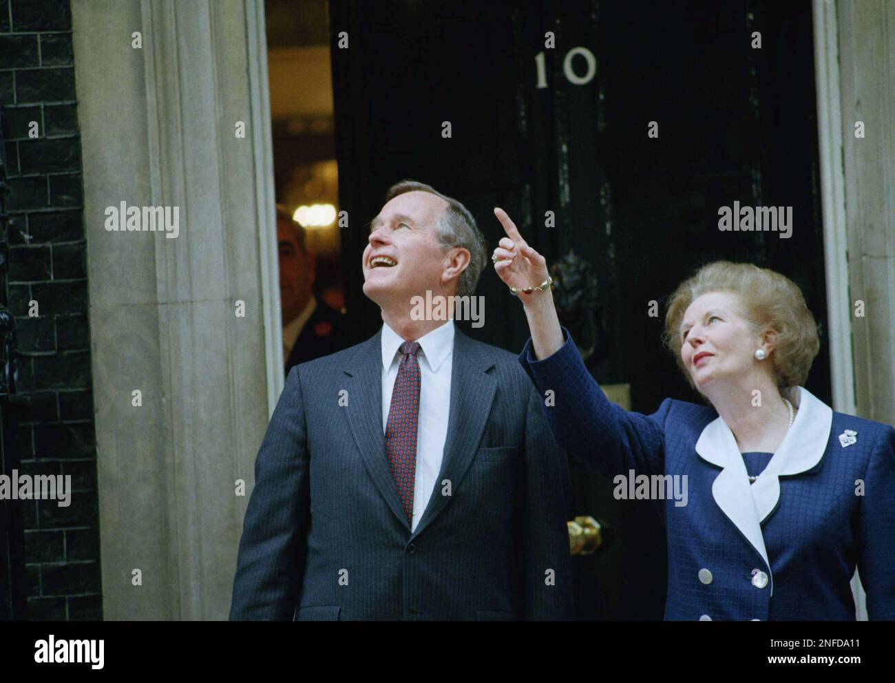 U.S. President George Bush and Prime Minister Margaret Thatcher point ...