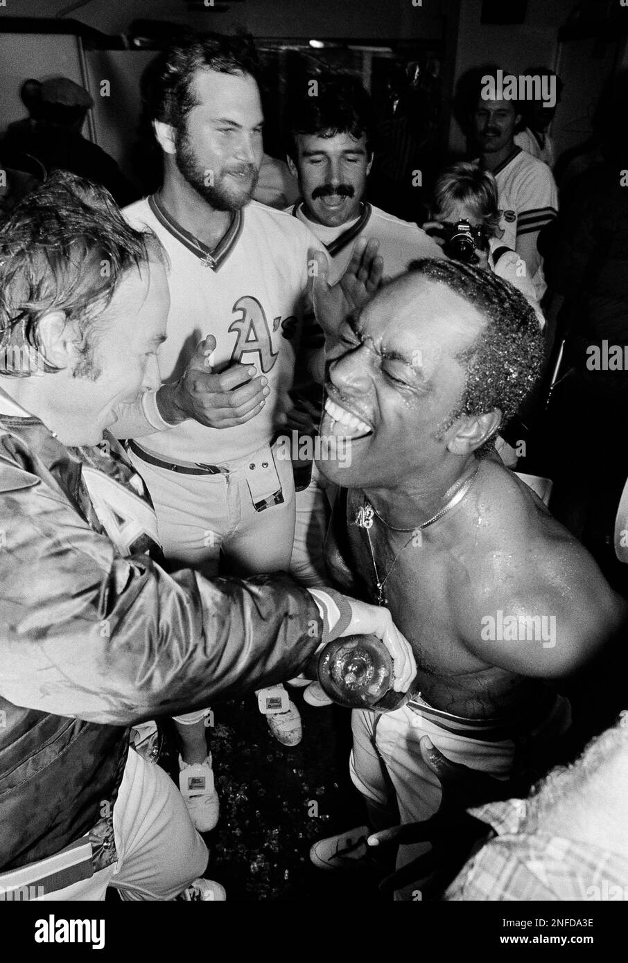 Oakland's Shooty Babitt gets a cold shower from a teammate as relief pitcher Bob Ochinko looks ...