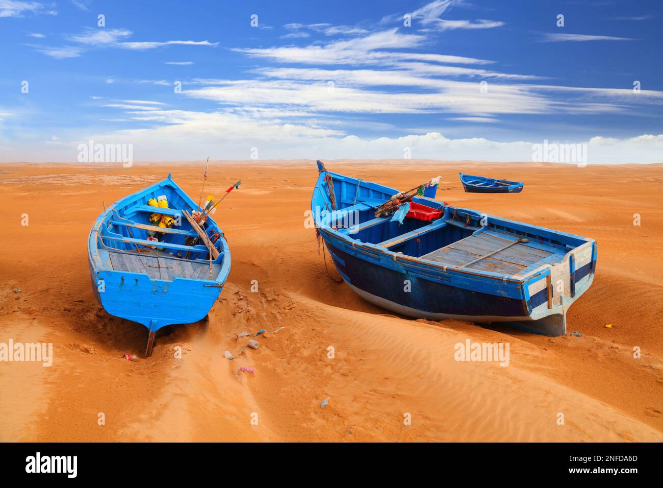 Morocco tourist attraction. Desert fishing boat in the sand near ...