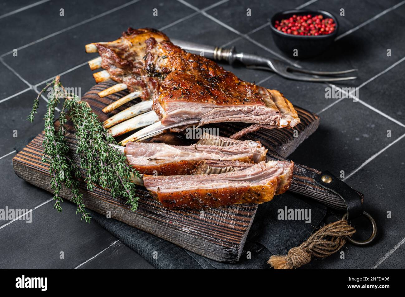Grilled Rack of lamb ribs, mutton spareribs on wooden board. Black ...