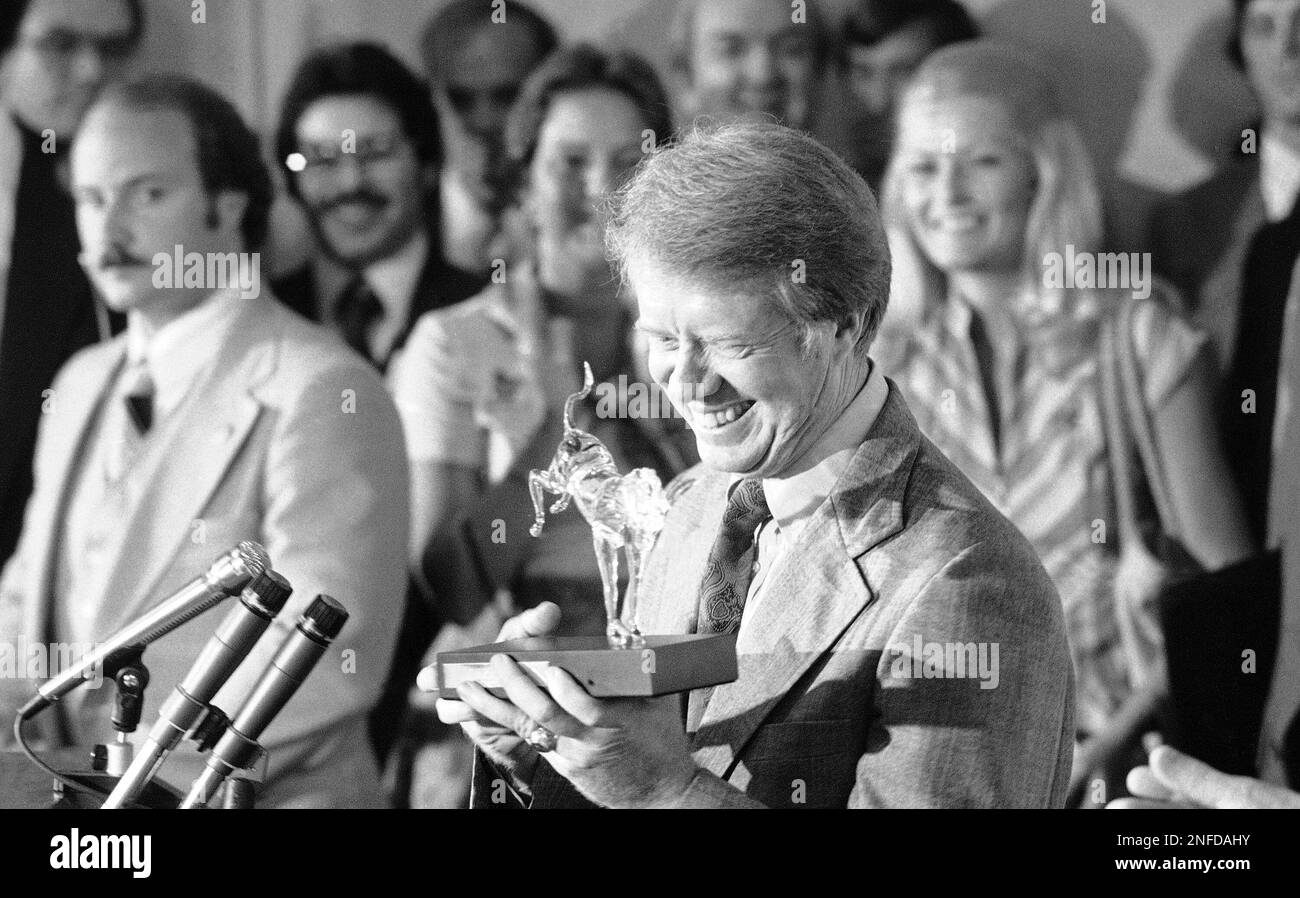 Jimmy Carter beams his appreciation after being presented with a glass ...