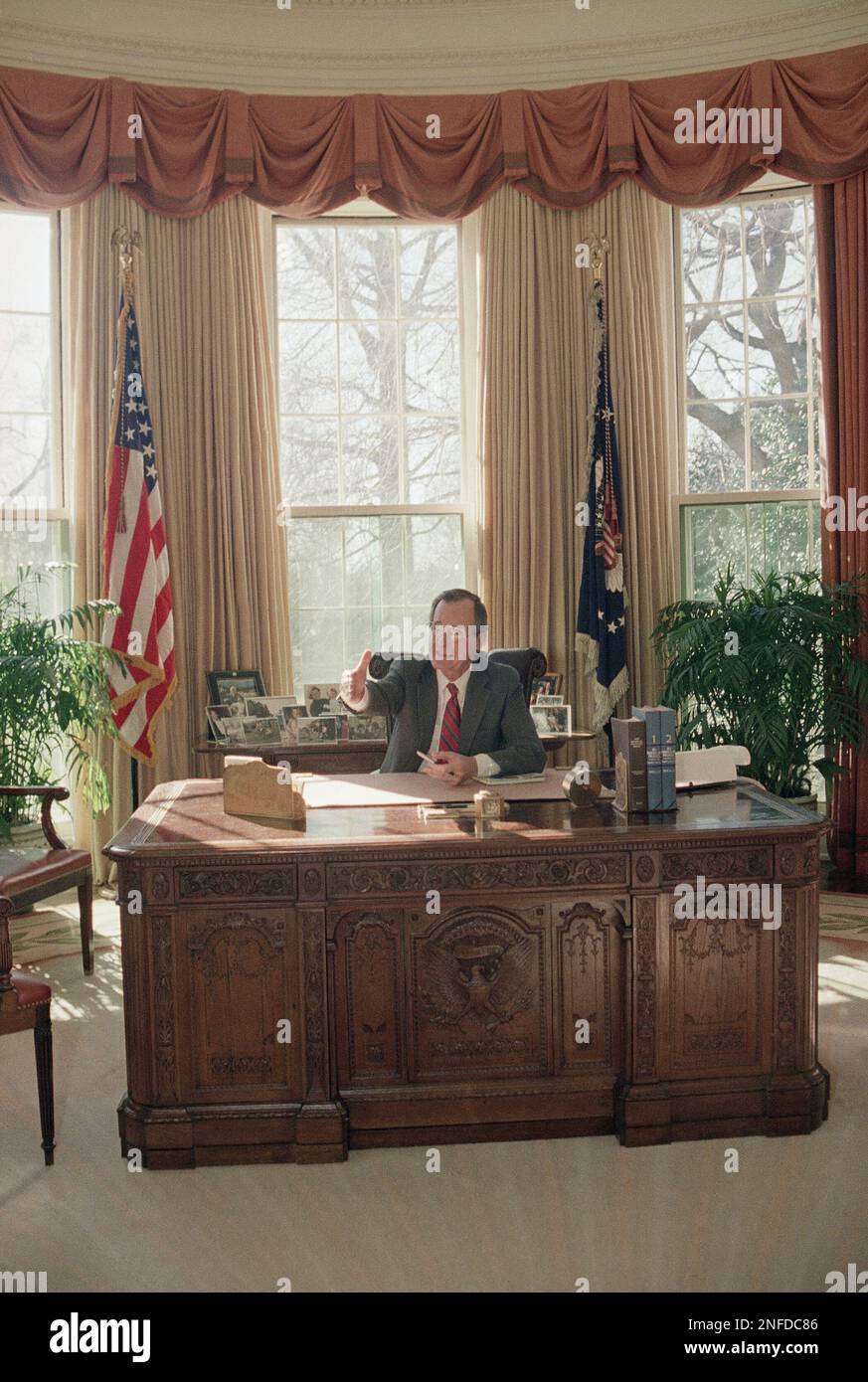 U.S. President George W. Bush sits at his desk in the Oval Office where ...