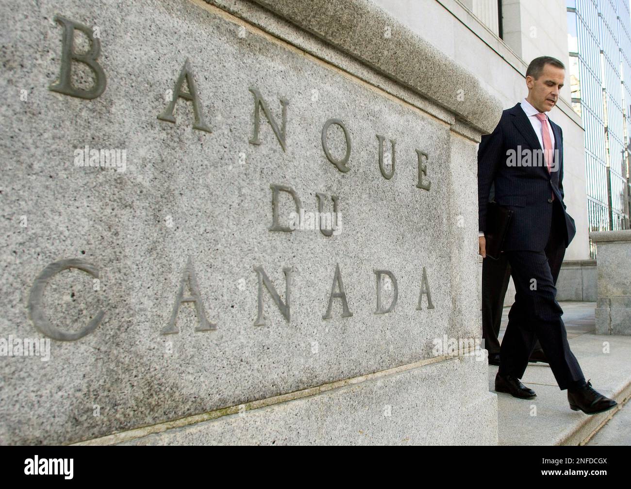 Bank of Canada Governor Mark Carney makes his way to a news conference ...