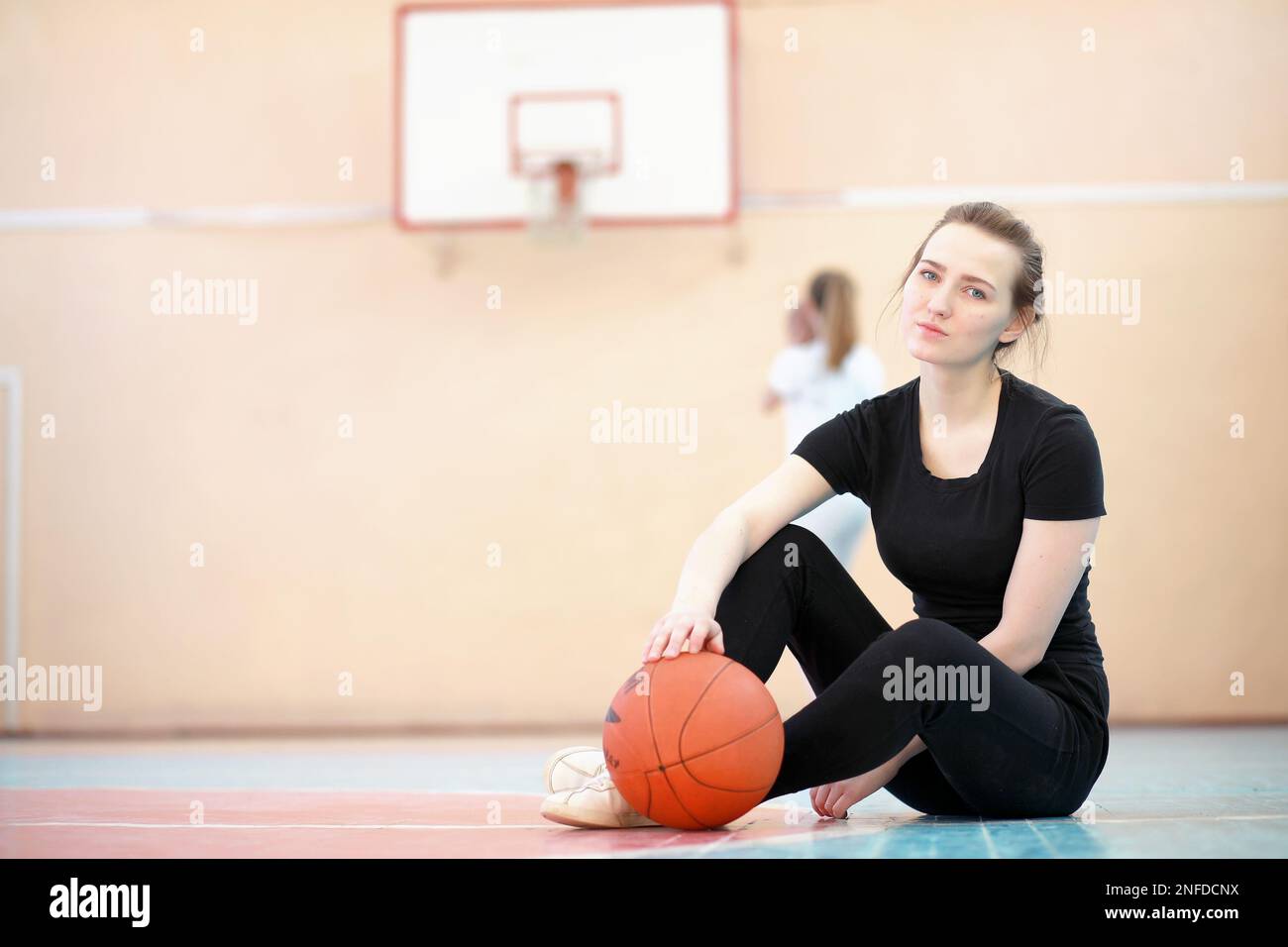 Girl young student in the gym playing a basketball Stock Photo - Alamy