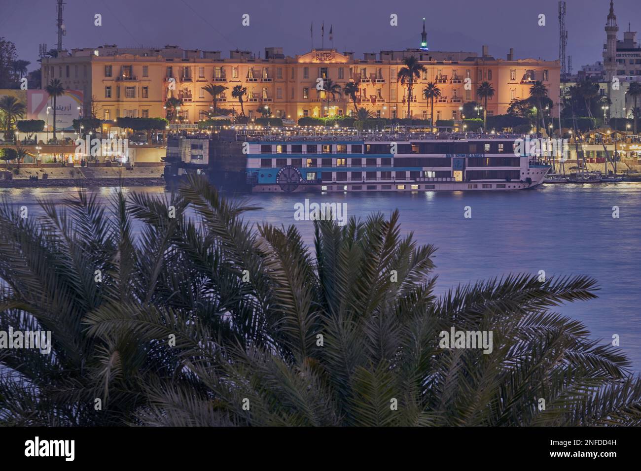 Luxor ,Egypt night shot from west bank showing Nile river with cruise ships , Feluccas and ...
