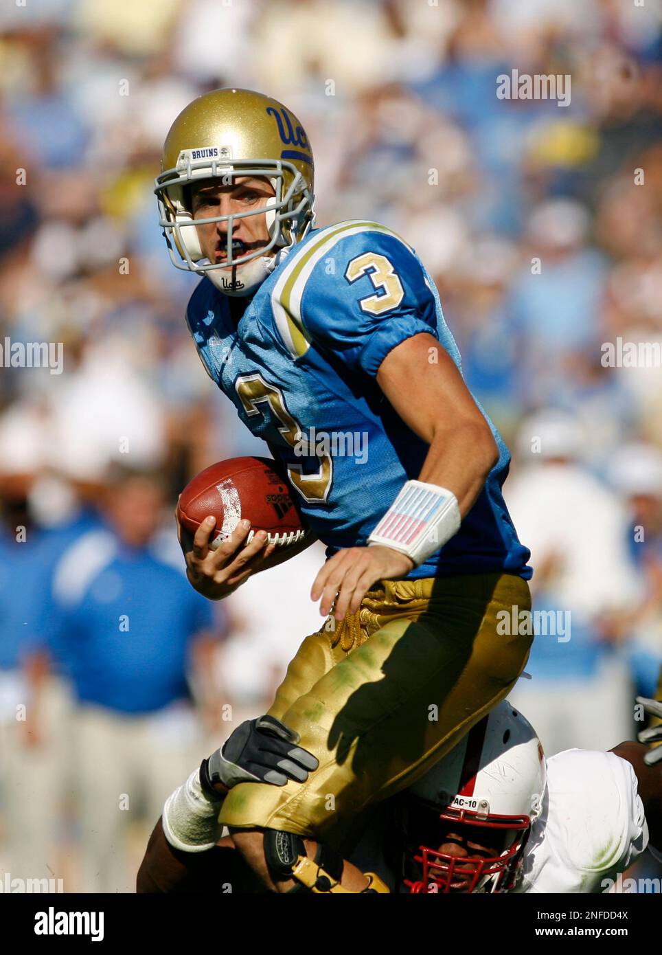 UCLA quarterback Kevin Craft is tackled against Stanford during an NCAA ...