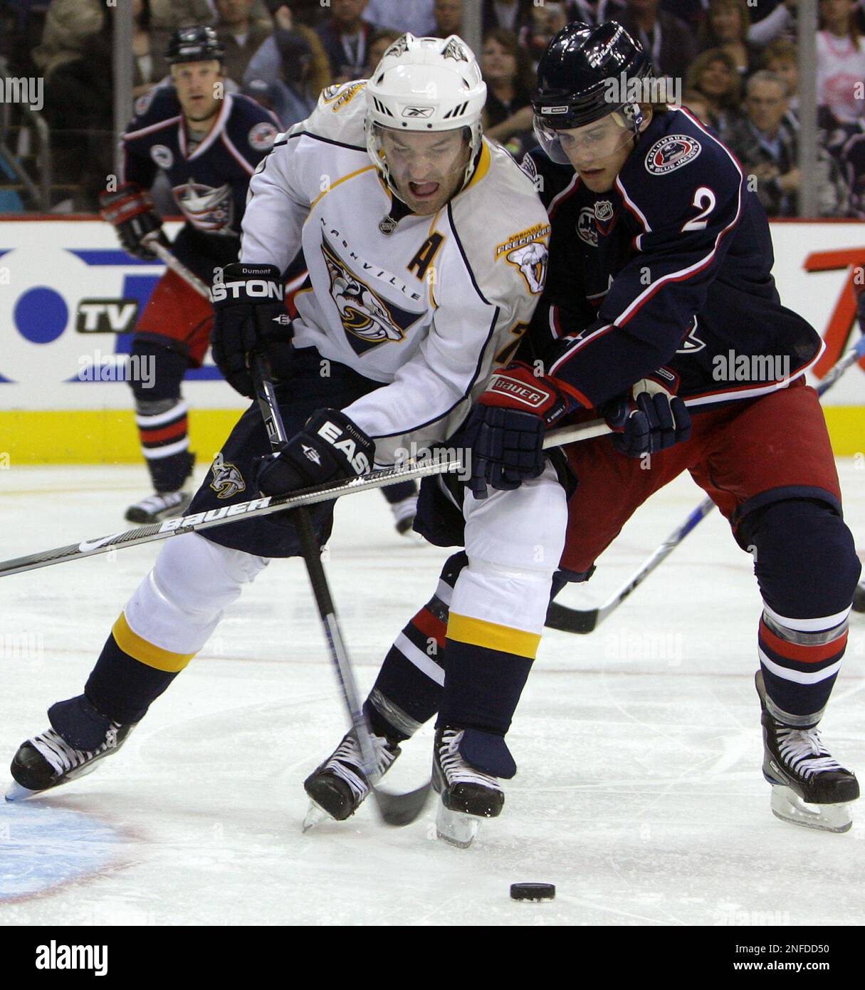 Columbus Blue Jackets' Kris Russell, right, and Nashville Predators' J ...