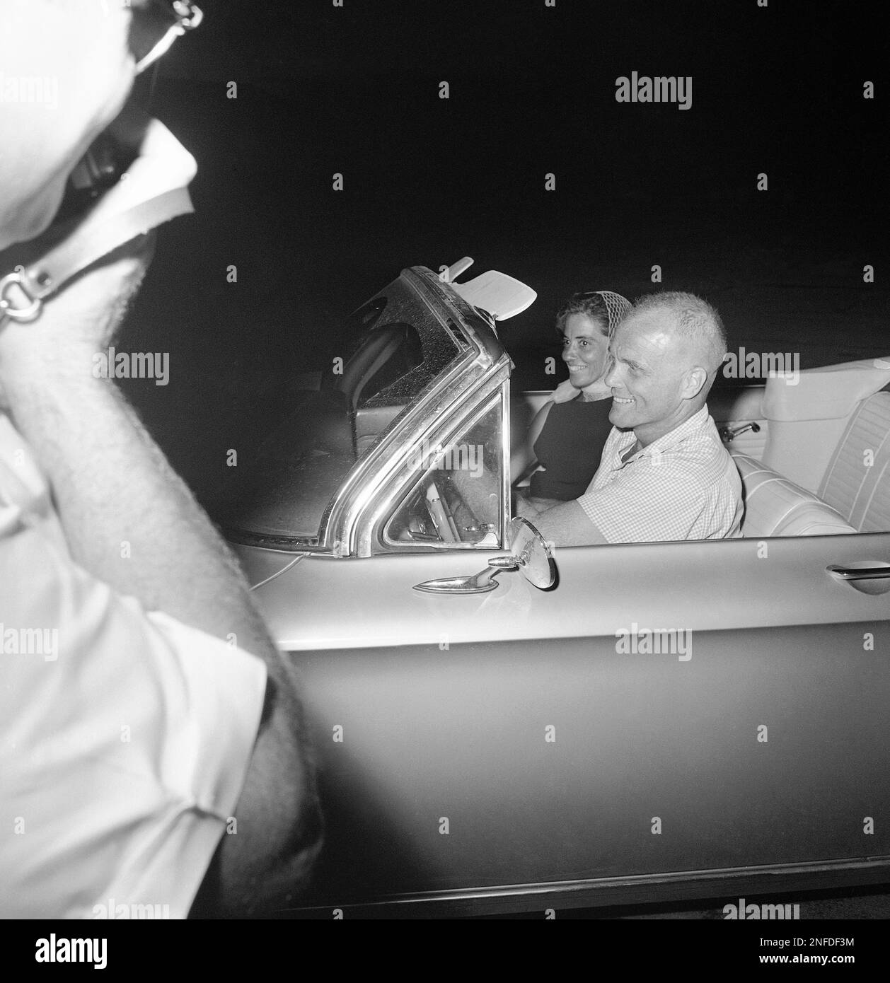 Lt. Col. John Glenn, is back behind the wheel of his car with his wife ...