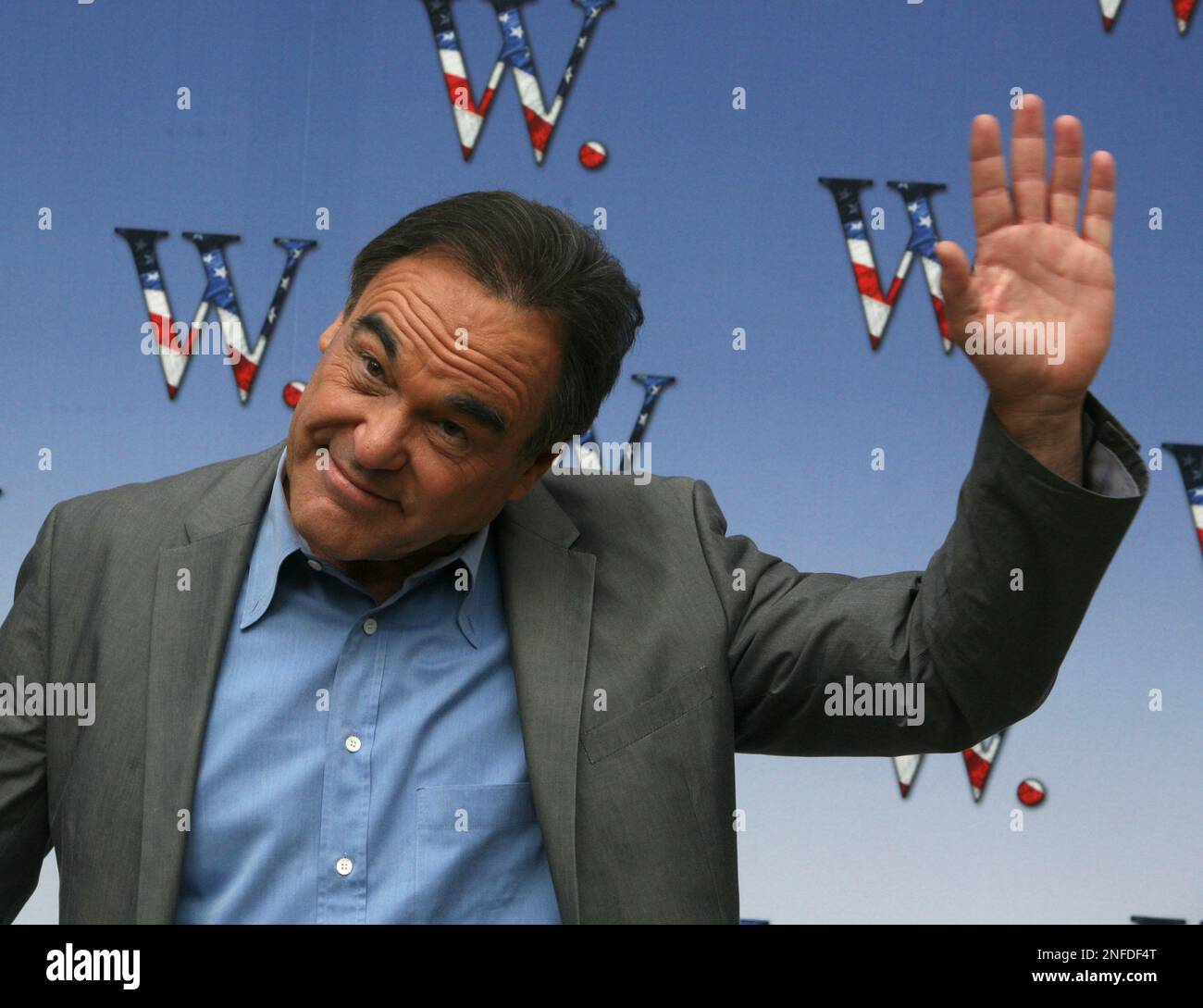 U.S. film director Oliver Stone gestures during a photocall as he ...