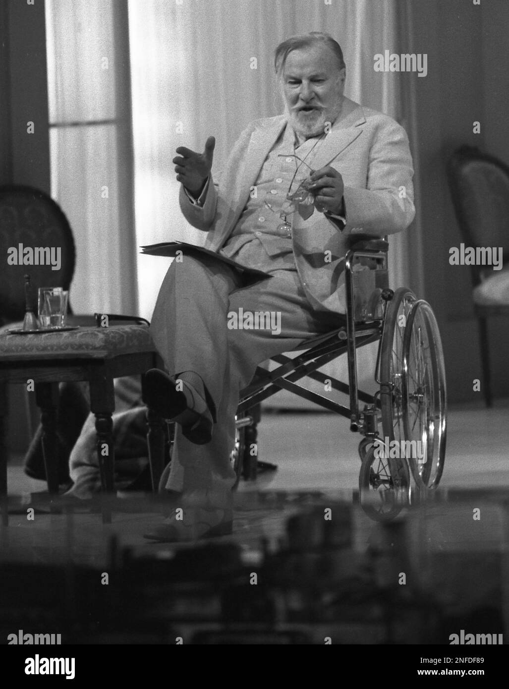 West German actor Martin Held congratulates sits in a wheel chair ...