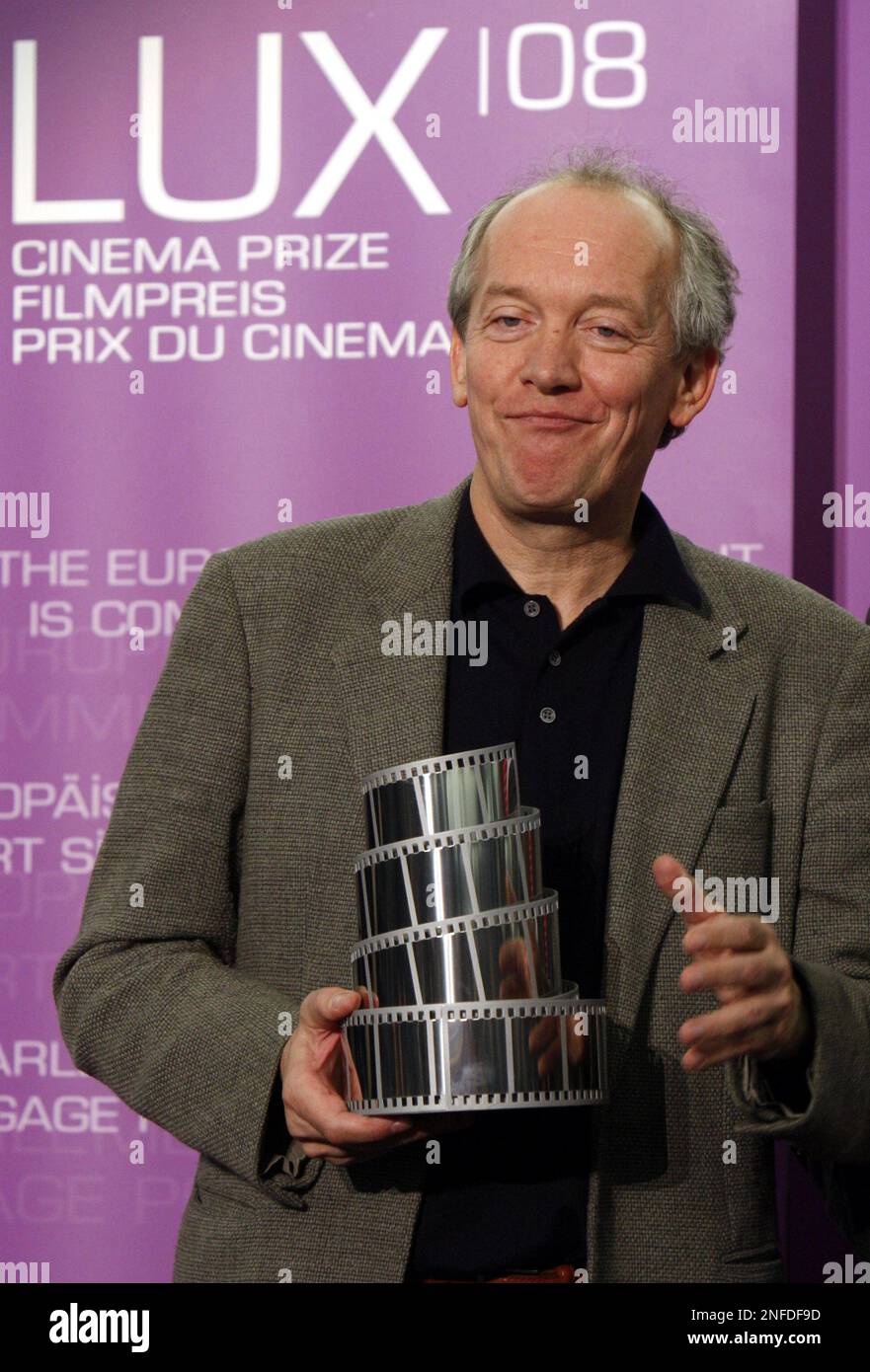Belgian film director Luc Dardenne holds the trophy, the European ...