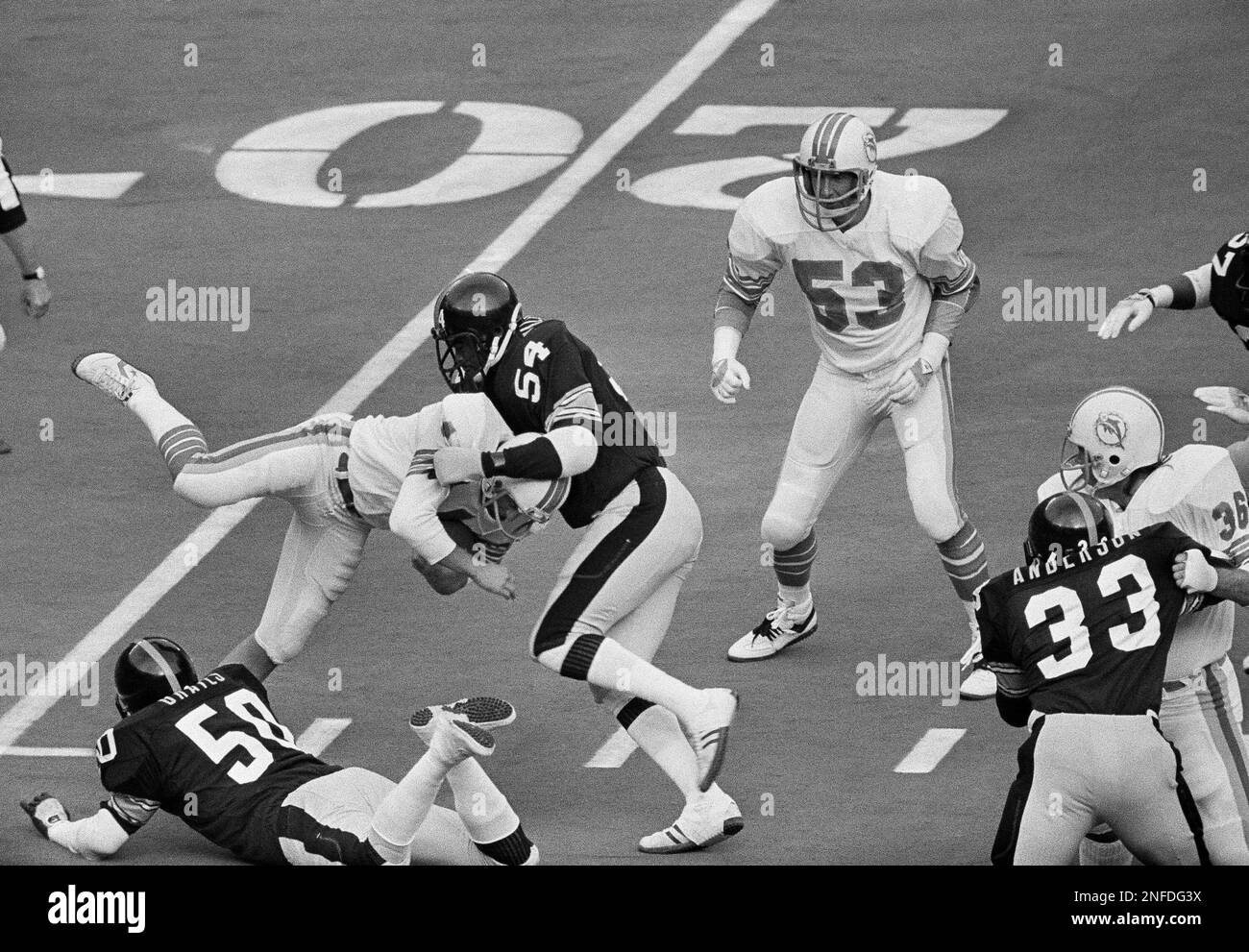 Miami Dolphins' punter George Roberts, is hit high by Pittsburgh ...