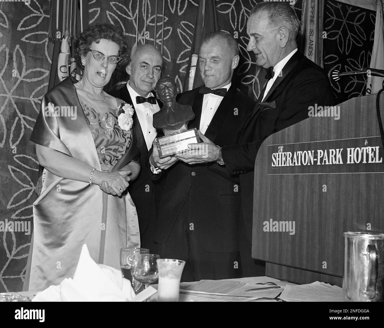 Astronaut John Glenn, second from right, holds the Robert H. Goddard ...