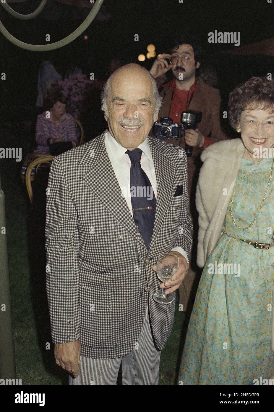 Director Frank Capra, left, with his wife Lou Capra, at a party in ...