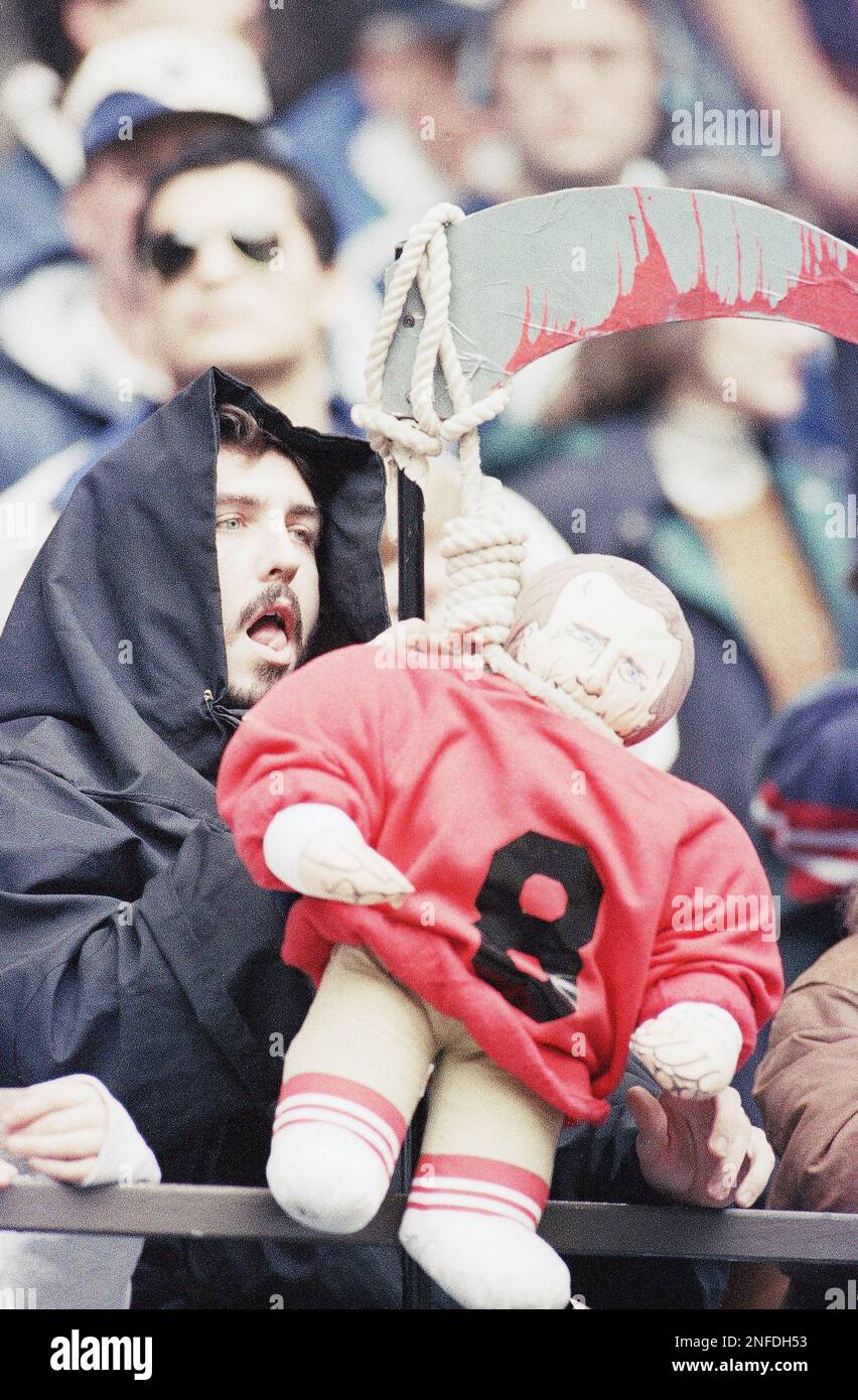 Dressed as the grim reaper, Dallas Cowboy fan Bob Neville hangs a doll ...