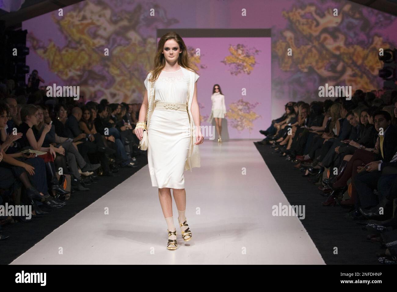 A model wears an outfit on the runway during the Mango show, part of ...