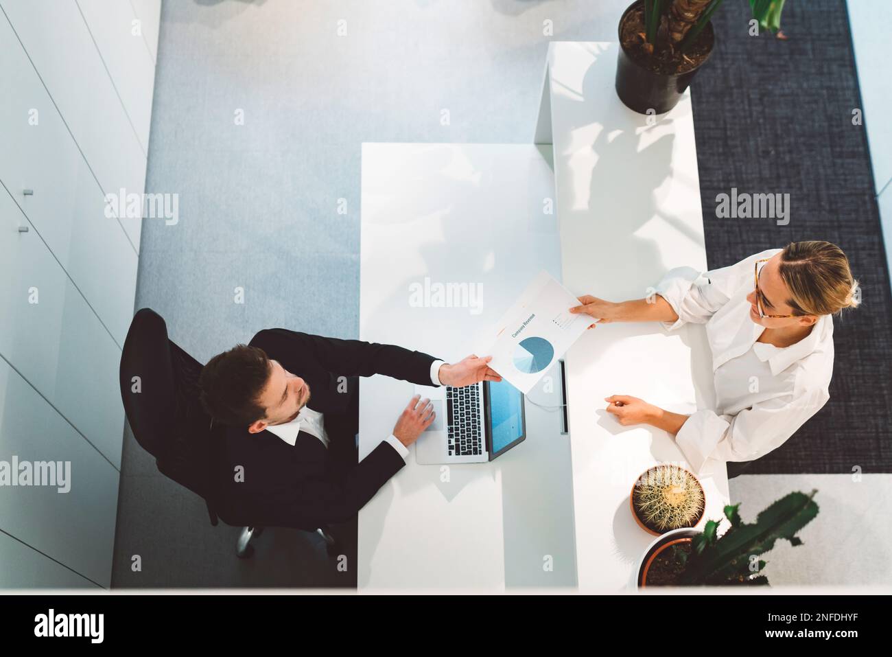 Top down view at a receptions desk at modern offices, while young woman ...
