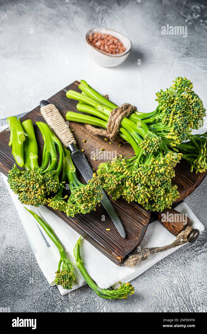Fresh bunch of Broccolini sprouts on cutting board ready for cookining ...