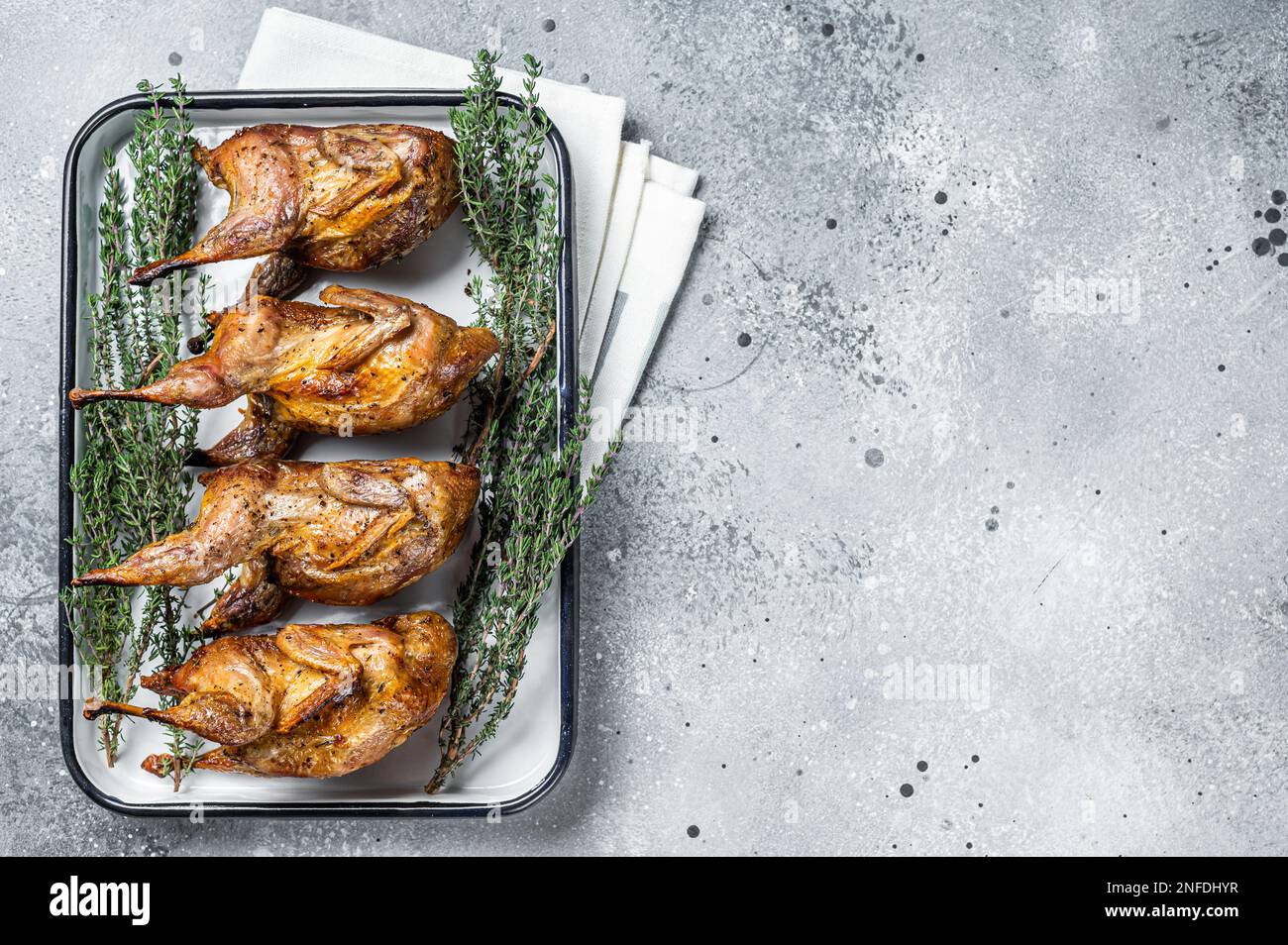 Homemade sticky Roast quails with spices and herbs in a baking dish ...