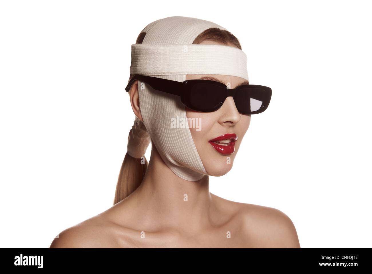 Female face bandaged with medical bandages and sunglasses with human ...