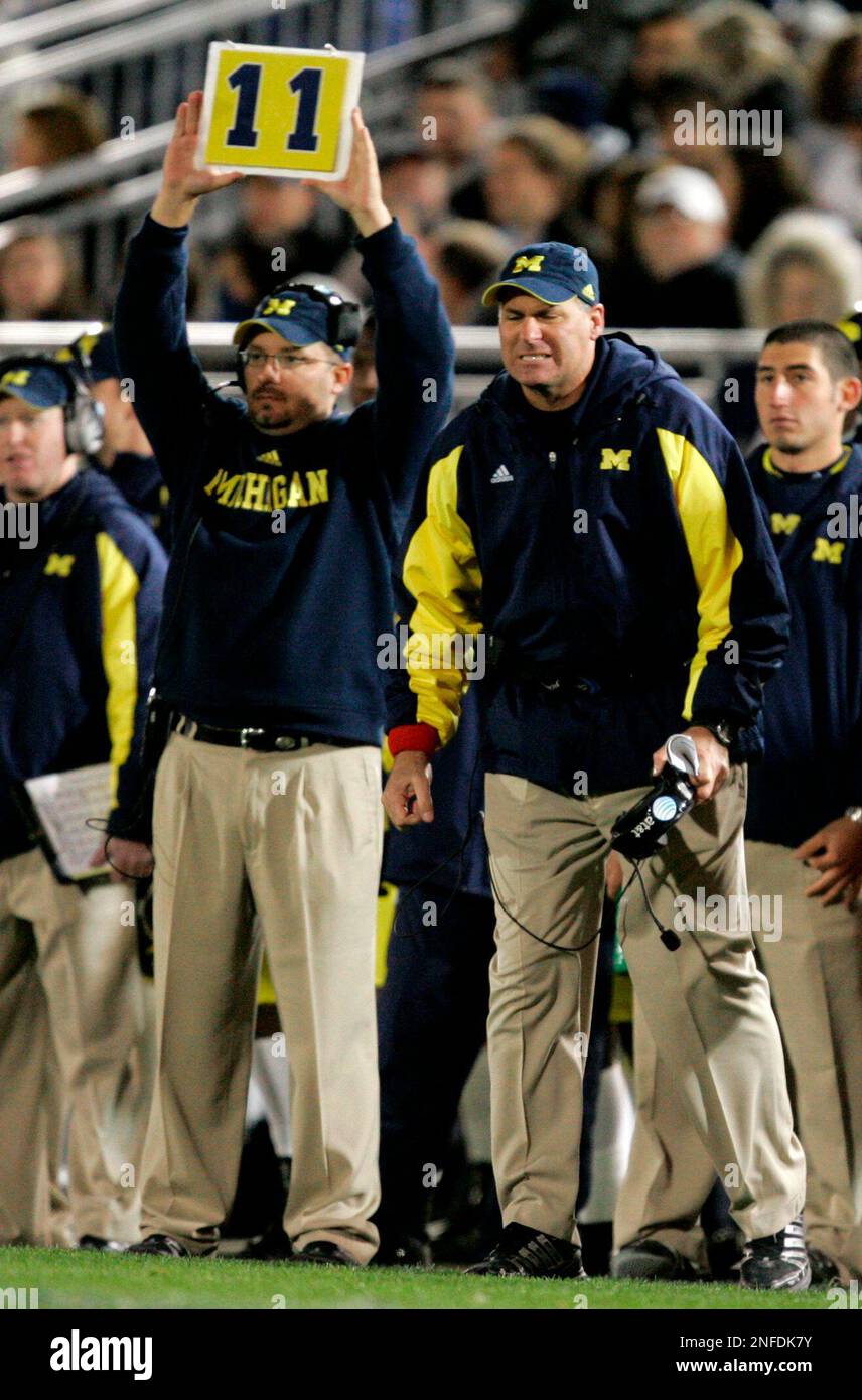 Michigan coach Rich Rodriguez, center, stands on the sidelines during ...