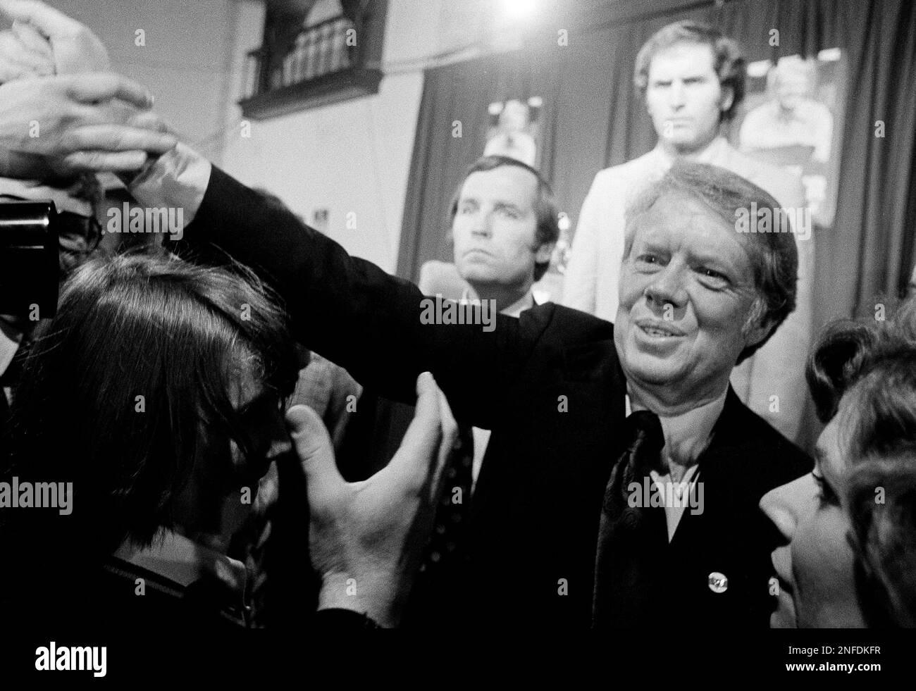 Former Georgia Gov. Jimmy Carter reaches into the crowd to shake hands ...