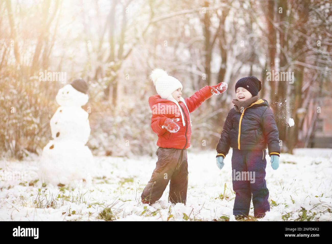 children in winter park play with snow Stock Photo - Alamy